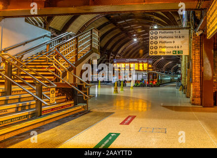York Railway Station at night. Steps lead up to a footbridge while ...
