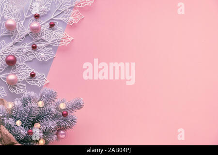 White winter twig with shiny geometric leaves and artificial Xmas tree ...