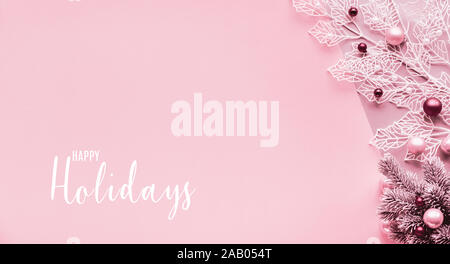 White winter twig with shiny geometric leaves and artificial Xmas tree ...