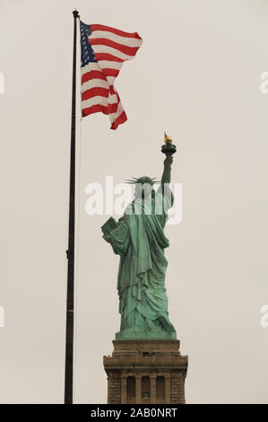 Back view of Liberty Statue with stars and stripes flag waving Stock ...
