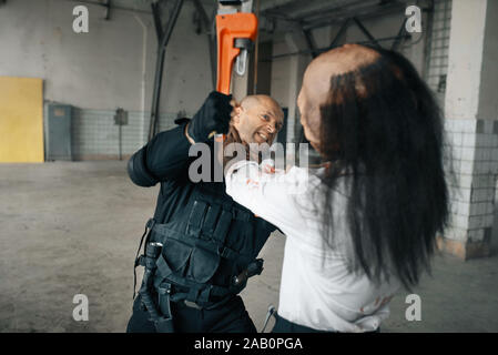Man fights with cruel zombie in abandoned factory Stock Photo - Alamy