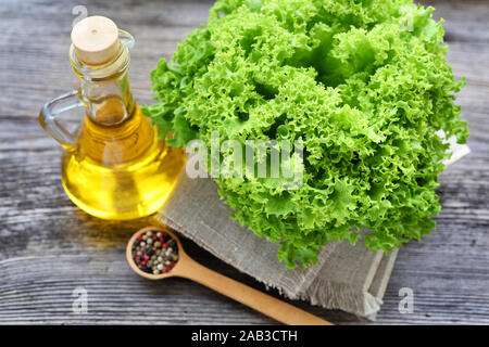 lettuce head, oil and seasoning over rustic wooden background Stock ...