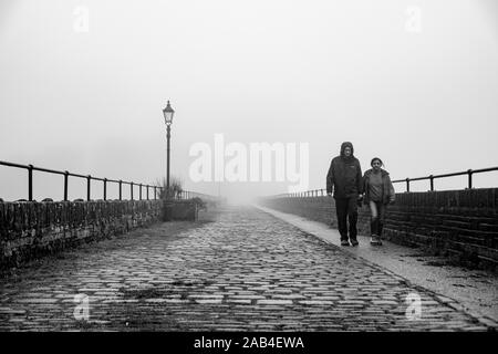 Walkers on The Promenade at Ogden Water nature reserve, Halifax, UK ...
