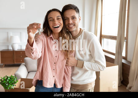 This is the key to my new start. Portrait of a happy young woman ...