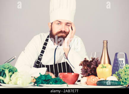 Bored chef lean on table at kitchen. Culinary inspiration. Hard day at ...