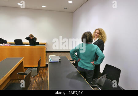 Augsburg, Germany. 26th Nov, 2019. A woman stands with her lawyer ...
