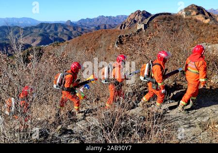 Chinese firefighters from the local forest firefighting brigade patrol ...