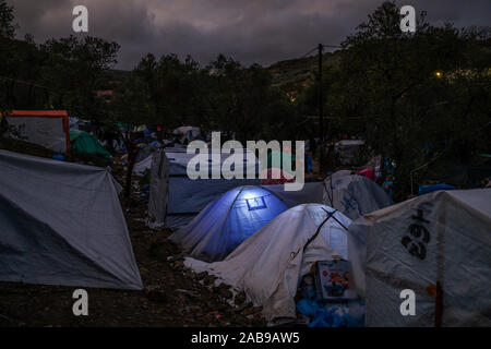 Lesbos, Greece. 25th Nov, 2019. A migrant tries to warm himself up at a ...