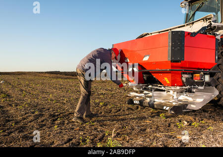 farmer preparing artificial fertilizers for work in field Stock Photo ...