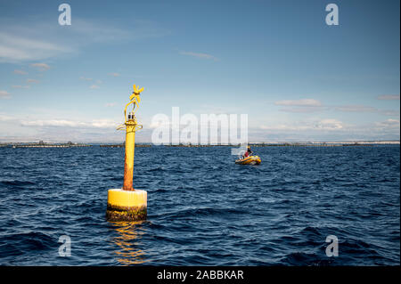 Buoying buoy in the sea with fishermen Spain Stock Photo - Alamy