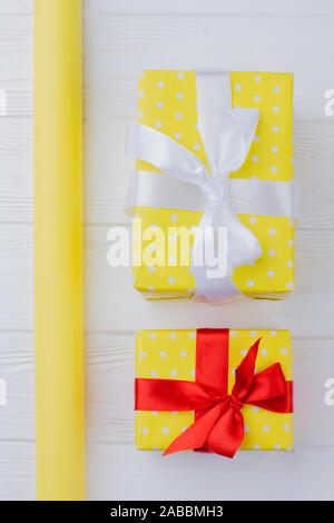 image of handmade wrapped gift boxes over wooden table covered with ...