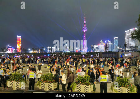 Tourists gather at the Bund to enjoy the light show performed with ...
