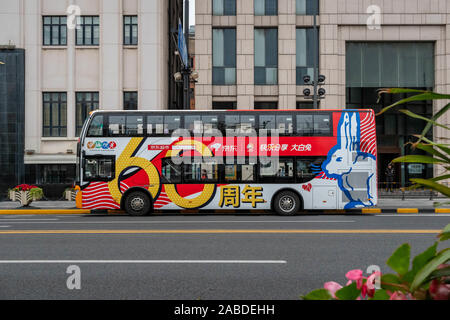 A sightseeing bus with the elements of White Rabbit Canday, a brand of ...