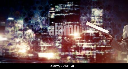 Close of businesswoman against night cityscape background and ...