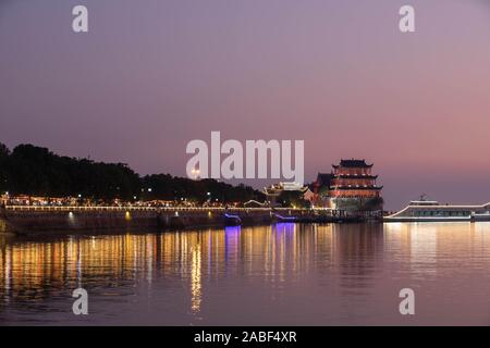 Fishermen on fishing boats work to catch fish with the setting sun ...