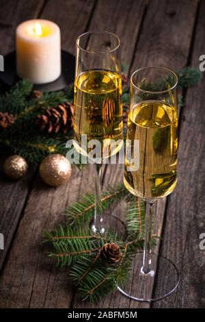Champagne glasses and christmas decor on black sparkling holiday ...