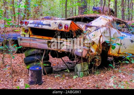 A wrecked and ruined old American car parked in the back streets of ...