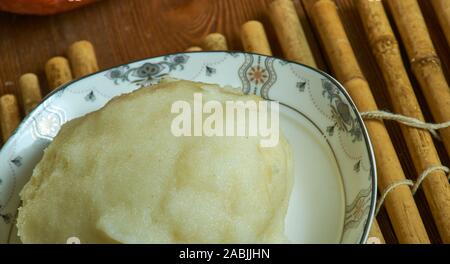 Fufu , mixing and pounding separate equal portions of cassava and green ...