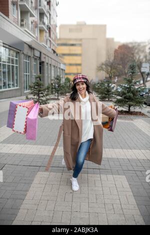 Woman holding many shopping bags Stock Photo - Alamy