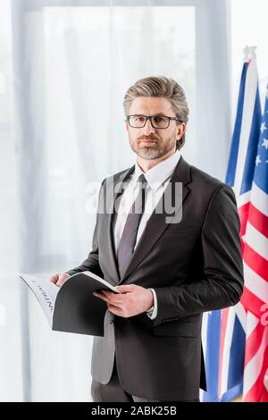 Handsome bearded man with USA flag on yellow background Stock Photo - Alamy