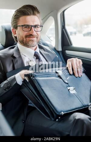 emotional man in a suit in a car a trip to work self confidence Stock ...