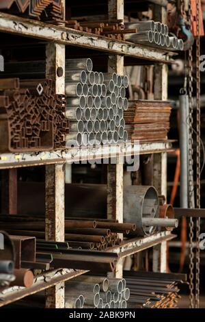 Different styles and sizes of old recycled metal pipes and profiles ...