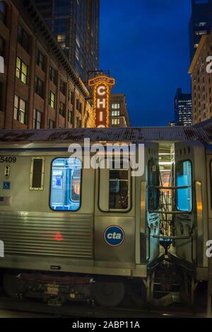 State and Lake L-railway platform with Chicago Theatre looming behind ...
