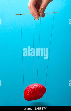 Hand of puppeteer on dark background Stock Photo - Alamy