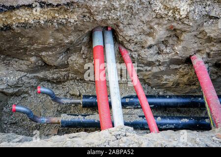 Insulated pipes for underground district heating. Connecting a new building to heat system Stock ...