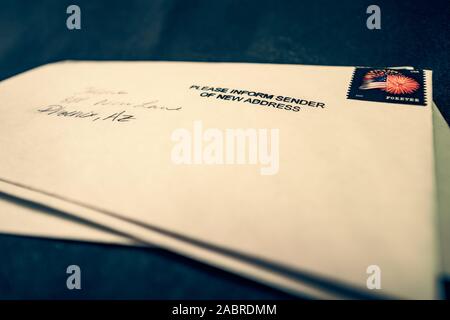 white envelope with change of address stamp Stock Photo - Alamy