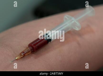 Young woman with syringe as a symbol for drug addiction Stock Photo - Alamy