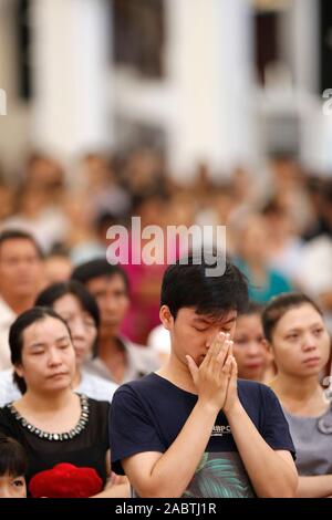 Thi Nghe catholic Church. Man praying the Virgin Mary. Ho Chi Minh city ...
