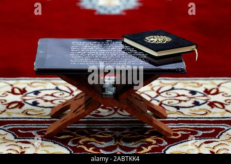 Digital Quran on a tablet and traditional Holy Quran on paper Stock ...