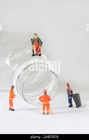 Miniature Garbage man recycling and cleaning a soft drink can to ...