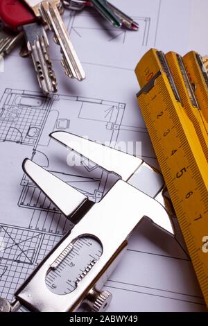 house blueprint, wood measuring stick, gauge and keys - real estate ...
