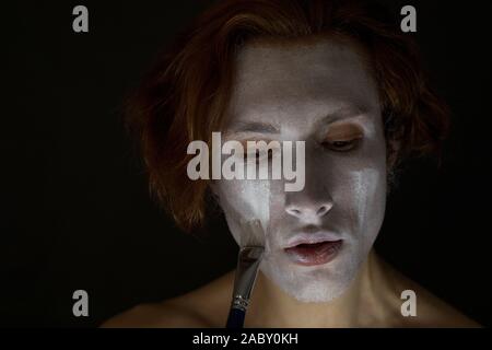 Man gets white paint on the face Stock Photo - Alamy
