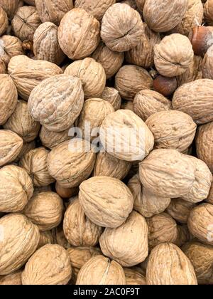 Closeup shot of the delicious walnuts in the bowl on the wooden surface ...