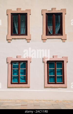 Classic window on beige wall Stock Photo - Alamy