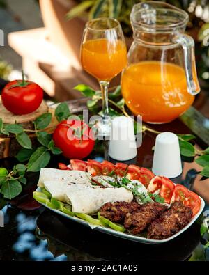 Grilled Lamb barbecue with onion and tomato Stock Photo - Alamy