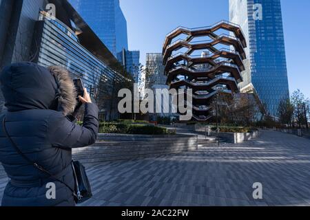 Woman with warm winter clothes taking a photo with her smartphone in ...
