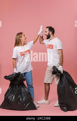 Man and woman, volunteers giving high five. Well-coordinated ...