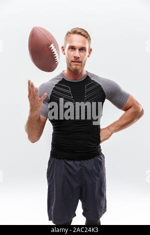 Confident rugby player holding ball at field Stock Photo - Alamy