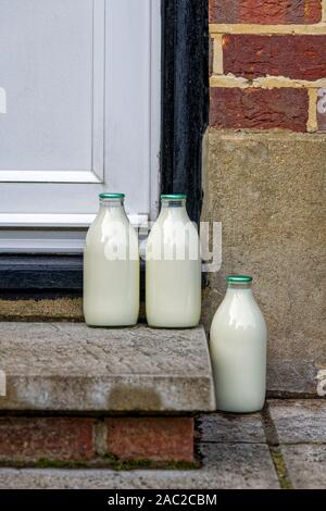 Traditional milk delivery three bottles of milk delivered by a milkman ...