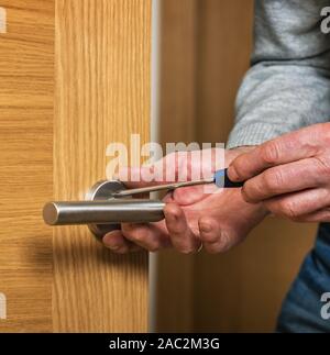 Hands of old man with screwdriver Stock Photo - Alamy