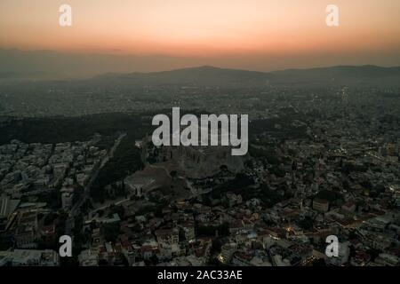 View of the city of Athens, during sunset. On the right there can be seen Acropolis and the ...