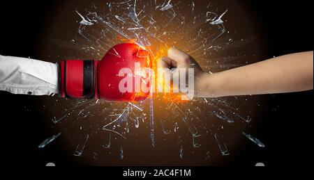 Two hands fighting and breaking glass into small pieces with fire and ...