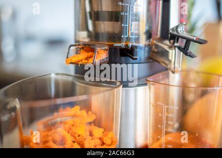 Close up of carrot pulp from process preparation of fresh juice in ...