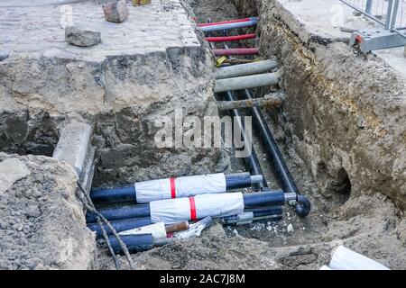 Insulated pipes for underground district heating. Connecting a new building to heat system Stock ...
