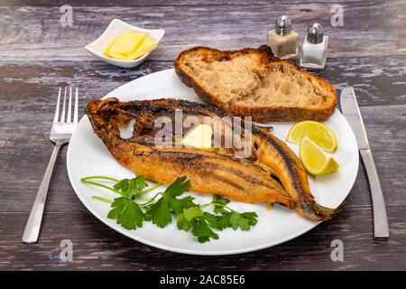 Kipper breakfast with crusty bread and butter - white background Stock ...