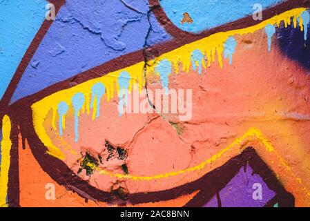 Detail of an anonymous street graffiti with many colors, cheerful urban ...